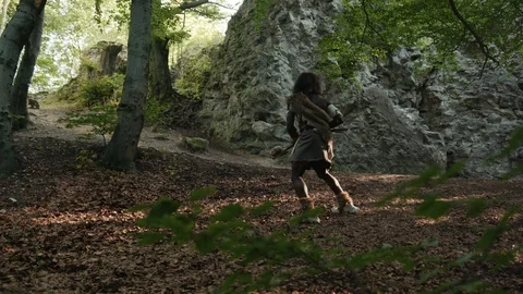 Primeval neanderthal hunter walking slow... | Stock Video | Pond5