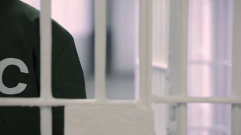 Prison back of inmate bars slider | Stock Video | Pond5