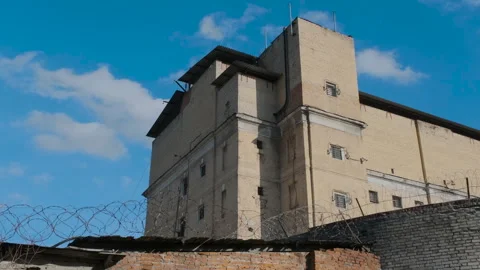 A prison behind a high fence with barbed... | Stock Video | Pond5