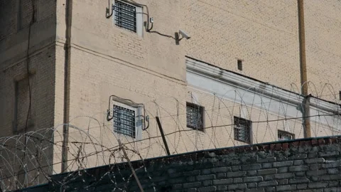 A prison behind a high fence with barbed... | Stock Video | Pond5