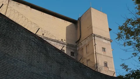 A prison behind a high fence with barbed... | Stock Video | Pond5