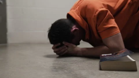 A prison inmate lays on ground crying, p... | Stock Video | Pond5