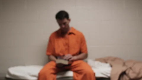 A prison inmate in orange prison uniform... | Stock Video | Pond5
