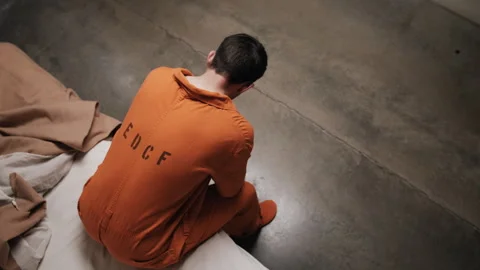 A prison inmate sitting on his bed in pr... | Stock Video | Pond5
