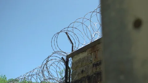 Prison or Jail Wall and Razor Wire | Stock Video | Pond5