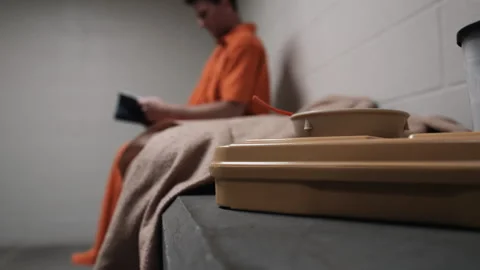 A prisoner in orange prison uniform, jum... | Stock Video | Pond5