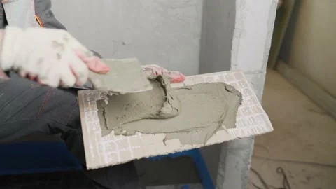 The process of applying glue to tiles. | Stock Video | Pond5