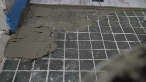 The process of laying ceramic floor tile... | Stock Video | Pond5