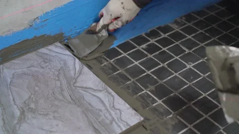 The process of laying ceramic floor tile... | Stock Video | Pond5