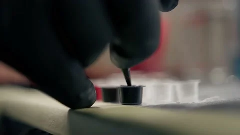 The process of pouring tattoo ink into a... | Stock Video | Pond5