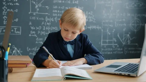 Prodigy kid taking notes in university c... | Stock Video | Pond5
