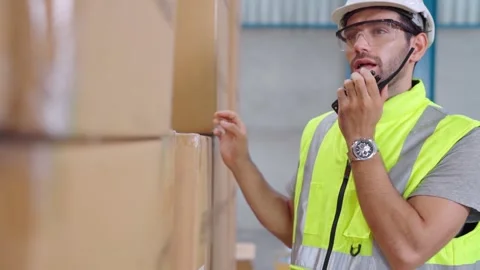 Professional cargo worker talks on porta... | Stock Video | Pond5