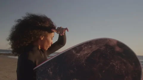 Profile of a Female Surfer Looking Out A... | Stock Video | Pond5