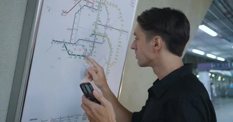 Profile view man looking for way on map,... | Stock Video | Pond5