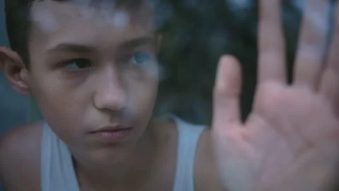 Profound Sadness: Close-Up of a Boy in D... | Stock Video | Pond5