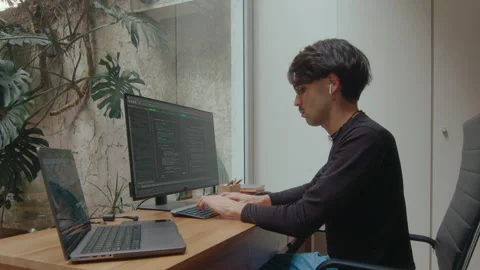 Programmer Coding Both on PC and Laptop ... | Stock Video | Pond5