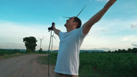 Progressive man with his EV car and wind... | Stock Video | Pond5