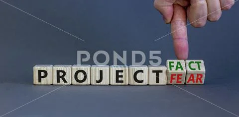 Photograph: Project fact or fear symbol. Businessman turns cubes ...