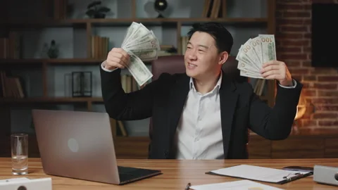Proud asian man fanning bills sitting at... | Stock Video | Pond5
