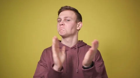 Proud man clapping hands over yellow bac... | Stock Video | Pond5