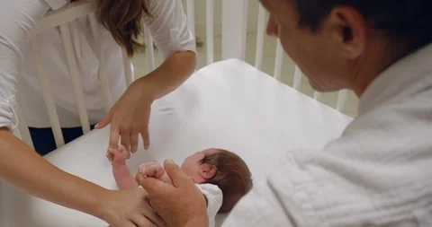 Proud new parents looking down at their ... | Stock Video | Pond5