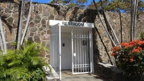 Public restroom with wrought iron gate | Stock Video | Pond5