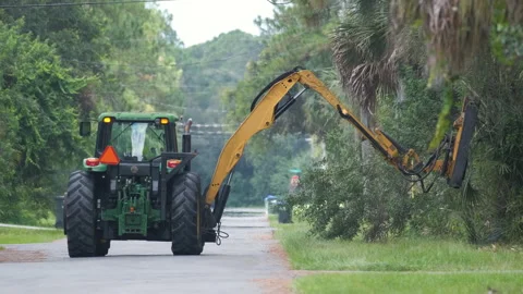 Public works utility tractor pruning tre... | Stock Video | Pond5