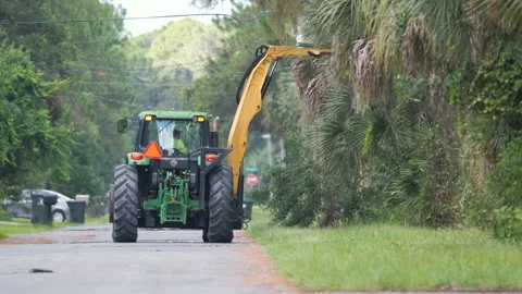 Public works utility tractor pruning tre... | Stock Video | Pond5