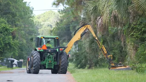 Public works utility tractor pruning tre... | Stock Video | Pond5