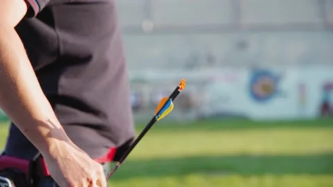 pulling an arrow out of the holster at a... | Stock Video | Pond5