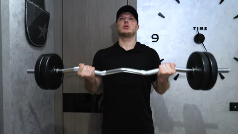 Pumping the arms of the biceps. A young ... | Stock Video | Pond5