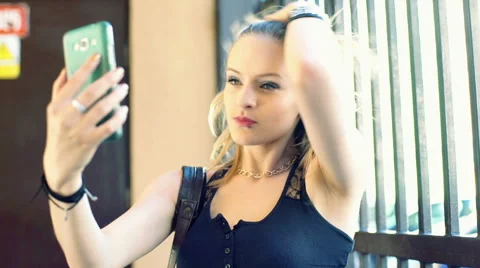 Punk girl looking to smartphone and doin... | Stock Video | Pond5