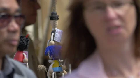 Puppets hanging from a street stall in P... | Stock Video | Pond5