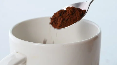 Pure cocoa powder falling into white cup... | Stock Video | Pond5