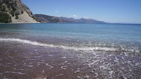 Pure transparent sea wave on a pebble be... | Stock Video | Pond5