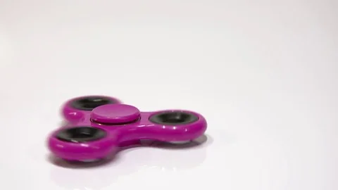 Purple spinner rotates on a white backgr... | Stock Video | Pond5