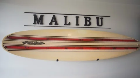 Push-in to a mounted red-striped surfboa... | Stock Video | Pond5