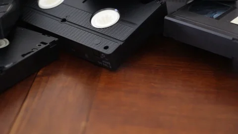 Put a Vhs cassette tape on the table | Stock Video | Pond5