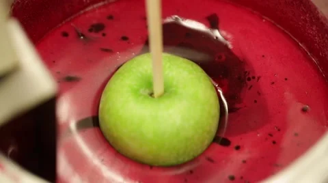 Putting apple in sugar syrup | Stock Video | Pond5