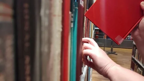 Putting A Book On The Library Shelf Univ... | Stock Video | Pond5