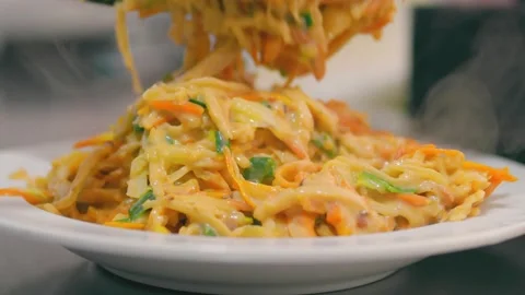 Putting cheese kottu on a plate. Local S... | Stock Video | Pond5