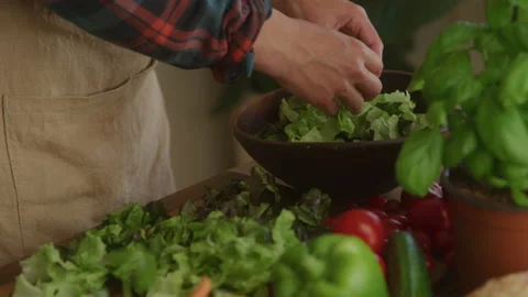 Putting Chopped Lettuce Into a Mixing Bo... | Stock Video | Pond5