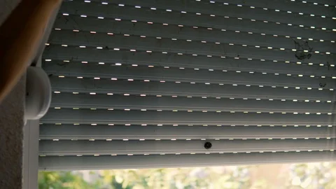 Putting down the window's blinds | Stock Video | Pond5