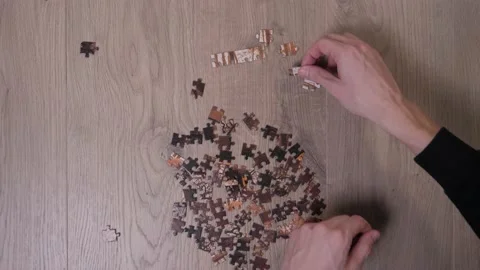 Putting jigsaw puzzle side pieces, top d... | Stock Video | Pond5