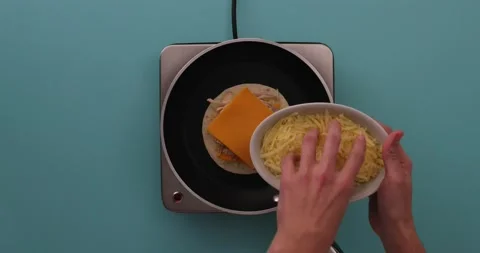 Putting shredded cheese on a slice of ch... | Stock Video | Pond5