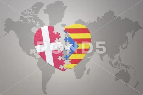 Puzzle heart with the national flag of catalonia and denmark on a world ...