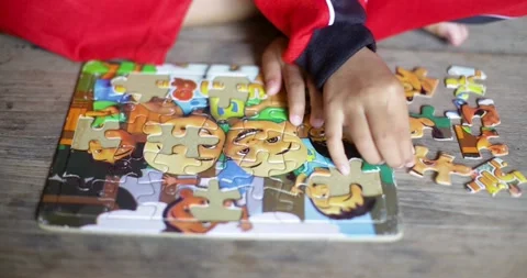 Puzzles. child's hand fold puzzle, close... | Stock Video | Pond5