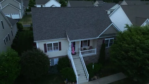 Quaint two story home with American flag... | Stock Video | Pond5