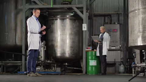 Quality control expert making notes in f... | Stock Video | Pond5