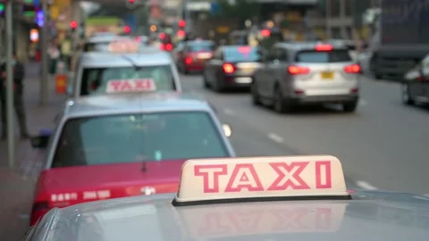 A queue of taxi cabs and lit signs sitti... | Stock Video | Pond5